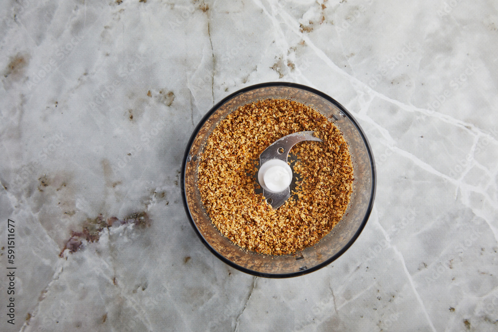 Crushed cookies in blender on marble table Stock Photo | Adobe Stock