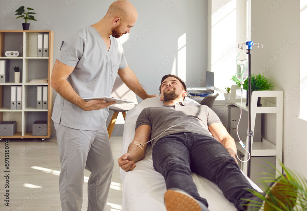 Young man lying on the couch at office in clinic and talking with a ...