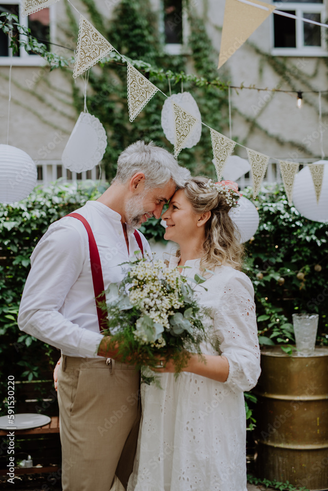 Mature bride and groom having a romantic moment at wedding reception ...
