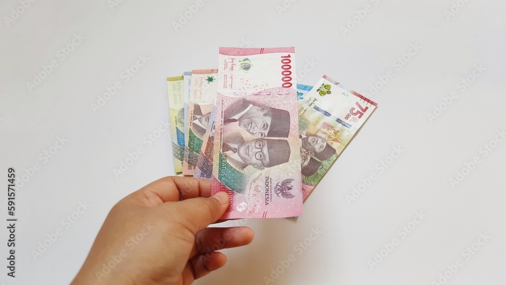 Hand holding showing indonesia rupiah, new rupiah money series ...
