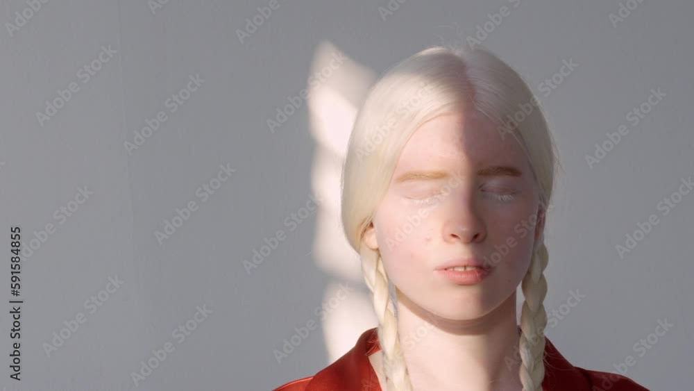 Gentle tender albino teen girl, pretty model with braids wearing red ...