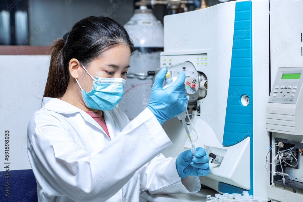 Scientist woman using micropipette for sample preparation with vial for ...