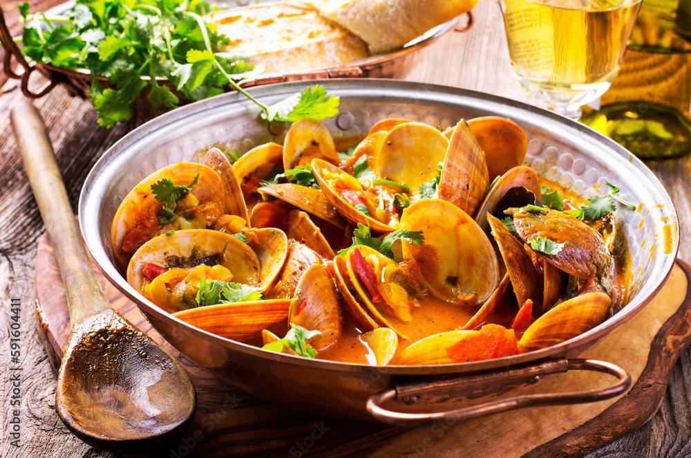 Traditional Portuguese seafood cataplana with vongole clam in white ...