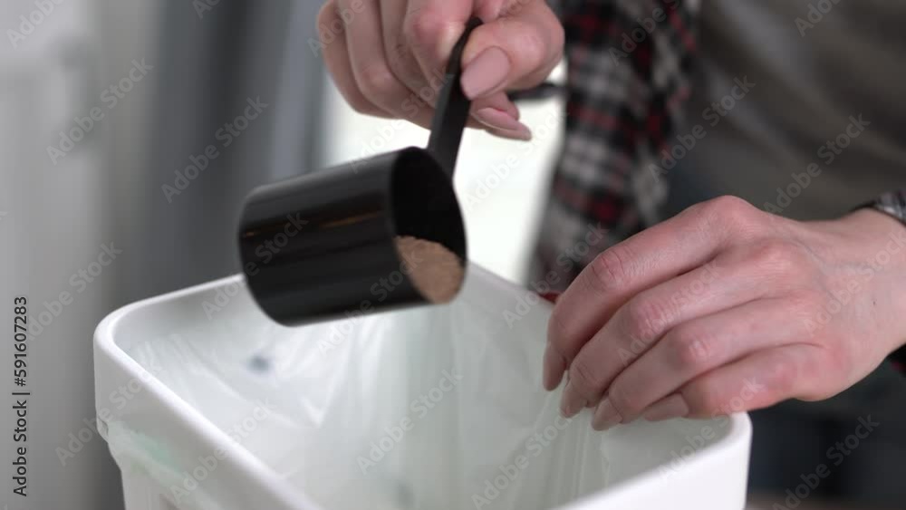 Video Stock Woman pouring bokashi ferment bran in a domestic compost ...
