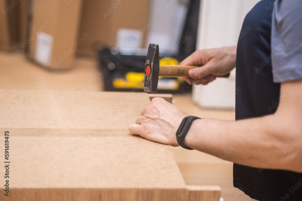 true handyman, close-up shot captures a man hand as he assembles ...