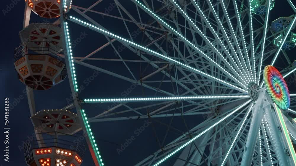 Ferris wheel. People having fun riding roller coaster at the amusement ...