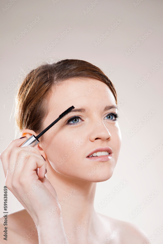 Head and Shoulders Portrait of Teenage Girl Putting on Mascara in ...