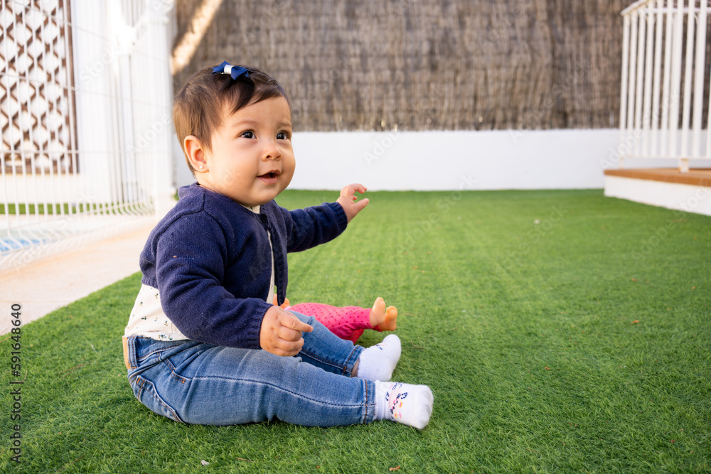 Adorable little baby girl with cute smile sitting unsupported and ...