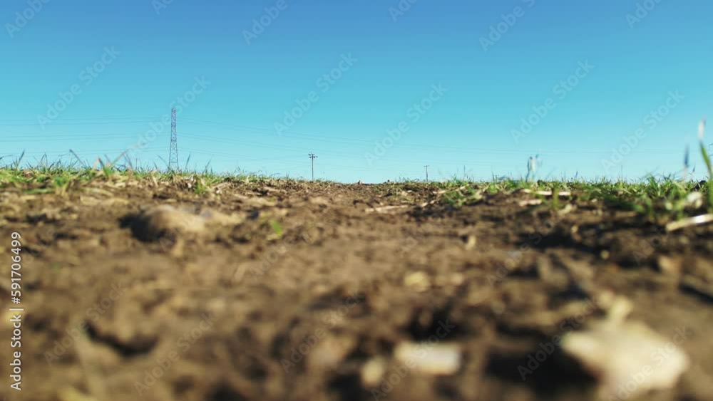 Surface view of masculine legs and feet walking towards camera in muddy ...