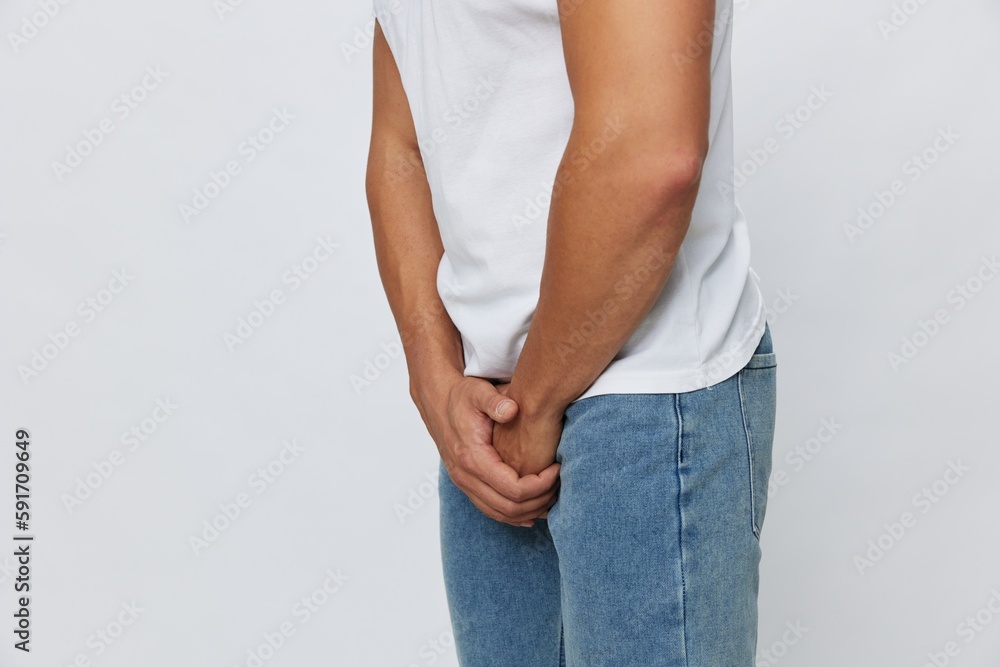 Man groin pain problems with potency and urination, urolithiasis, in white t-shirt on white ...
