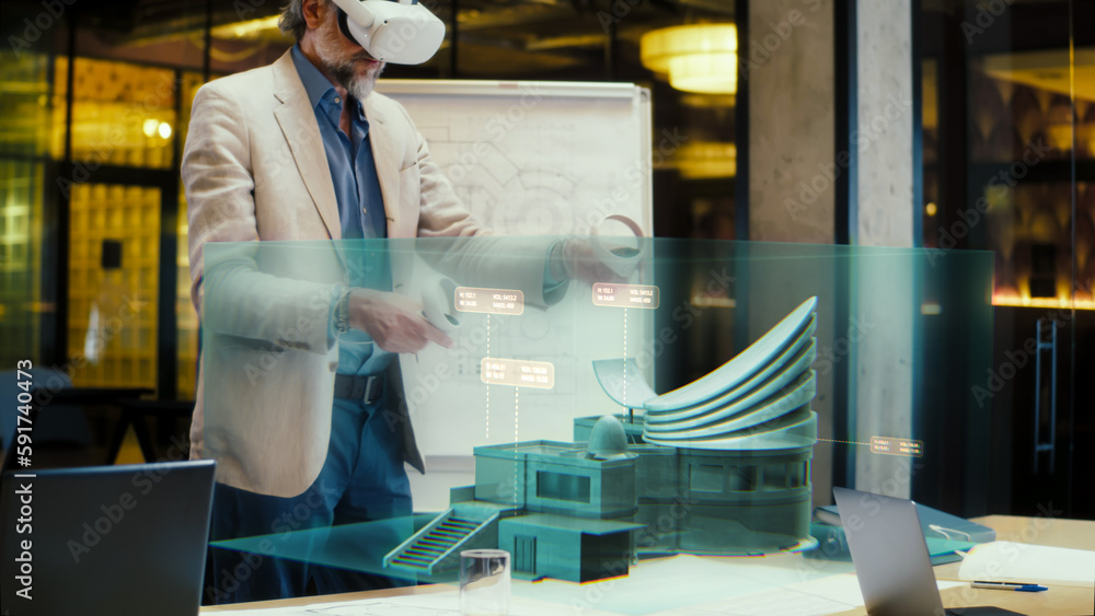 Male designer uses VR headset and wireless controllers, creates modern ...