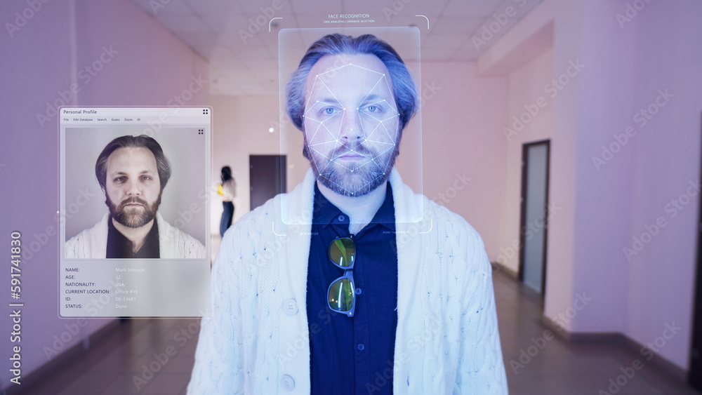 Adult man scans his face in coworking office. He touches sensor and ...