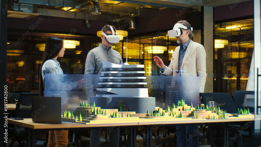 Male architect uses VR headset and wireless controllers, presents ...