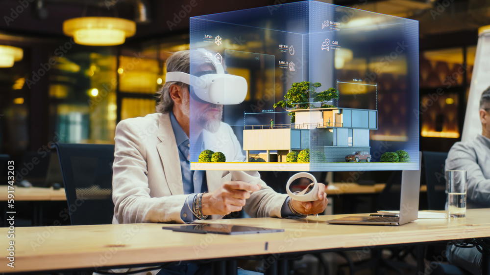 Male designer uses VR headset and wireless controllers, makes ...