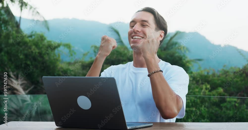 Shocked business man shows winning emotion looking into laptop monitor ...