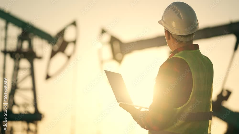 Oil pump.Engineer work with laptop and diagram.Checking operation of ...