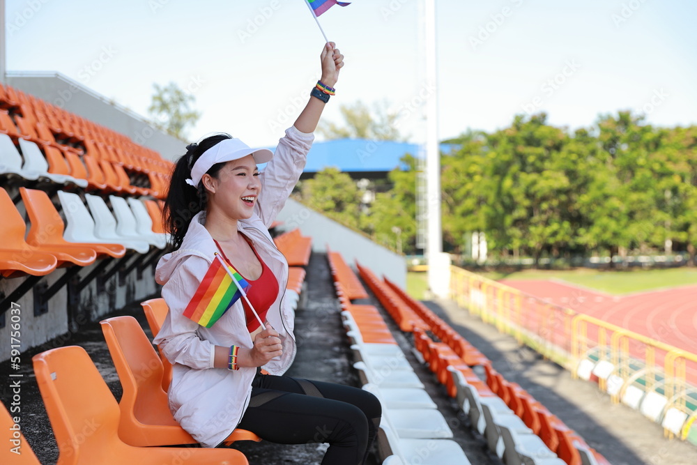 Happy and excited young female asian transgender LGBT sport fan ...