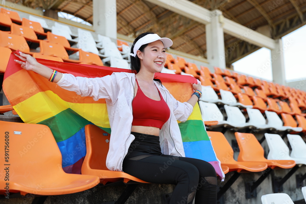 Happy and excited young female asian transgender LGBT sport fan ...