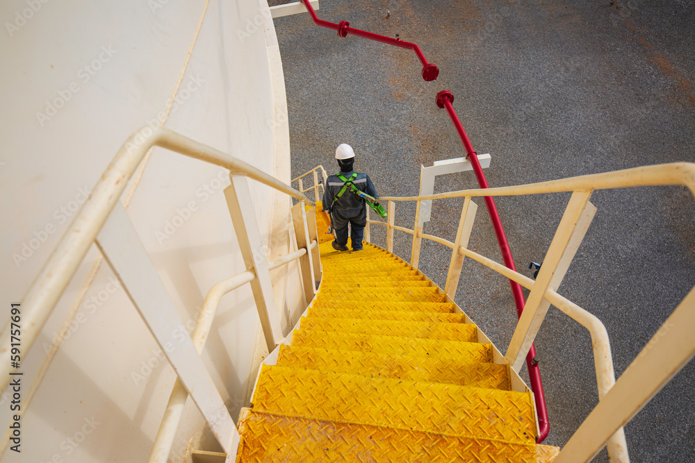 Male walking the down stairway inspection visual record storage tank ...