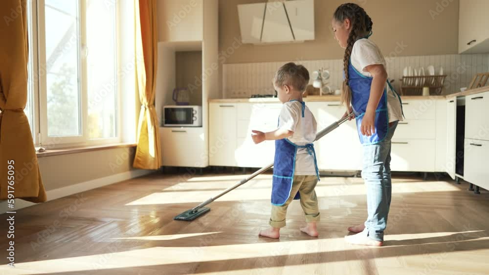 Happy children at home mopping floors.Clean house cleaning.Cute child ...