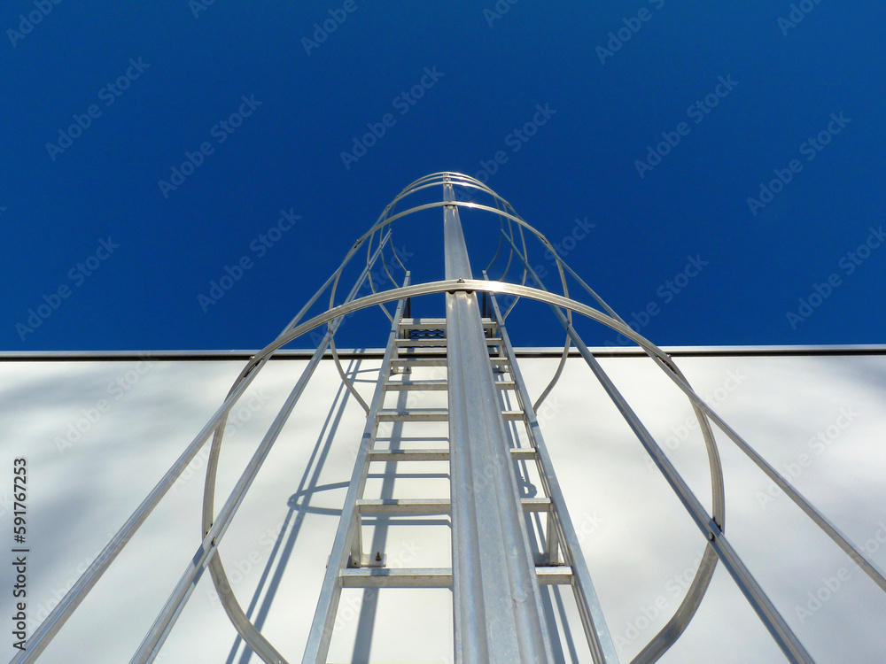 aluminum roof access ladder with safety cage in diminishing perspective ...