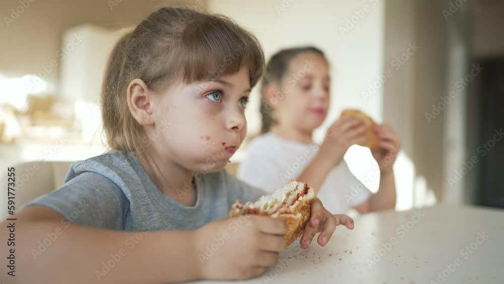 Group of kids eat burgers in cafeteria. School food. Fast food ...