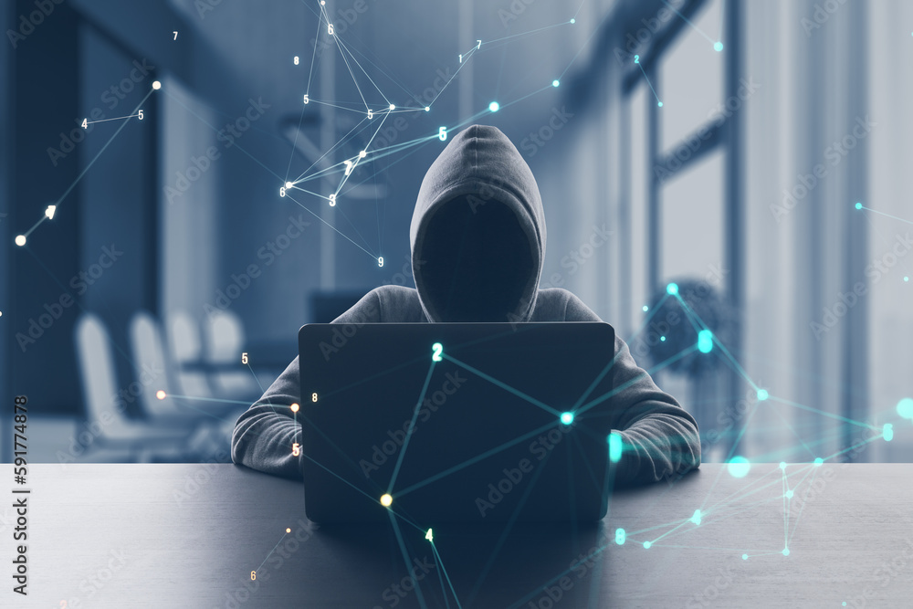 Hacker at desktop using laptop with glowing polygonal coding mesh on blurry office interior ...