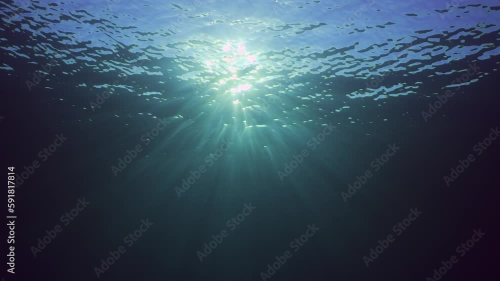 Sunlight at daytime penetrates through waves on water surface. Bright ...