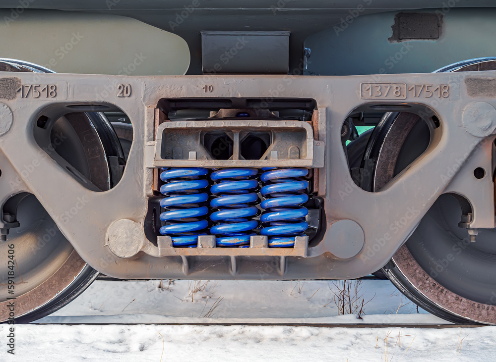 Suspension springs of a railway wheeled bogie on the snowy rails ...