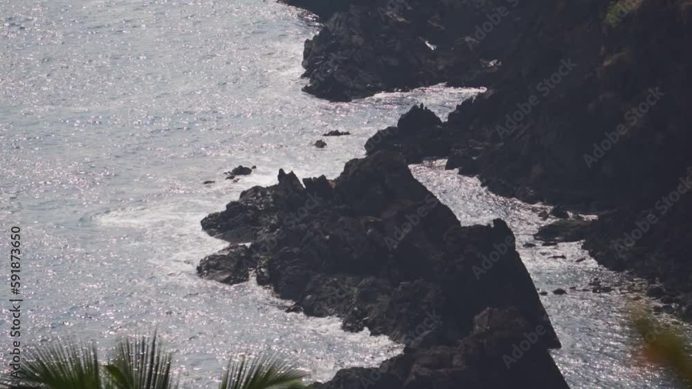 Sea waves striking the rock in the middle of the sea at Kakolem beach ...