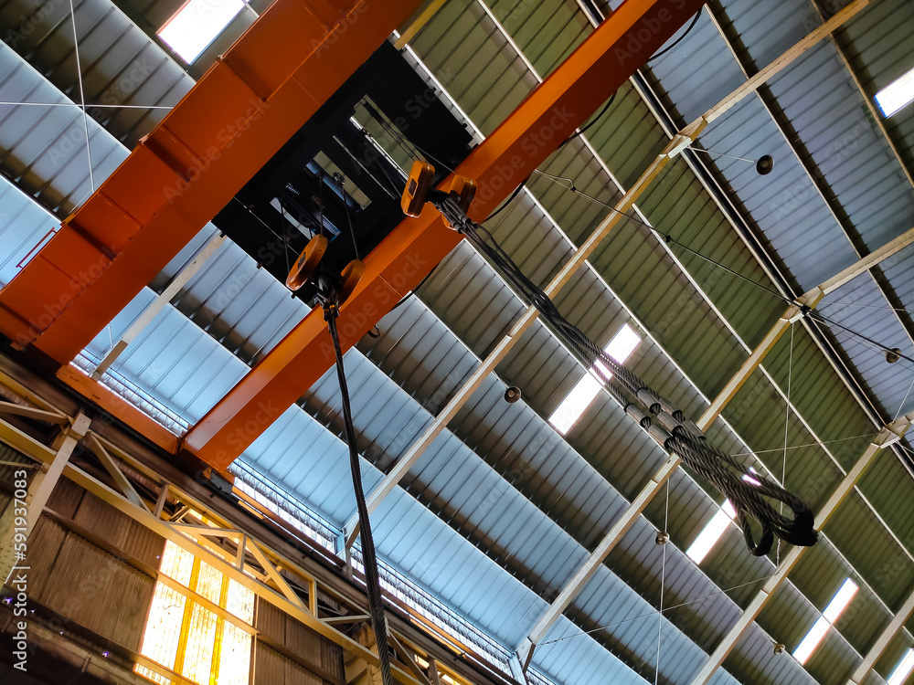 Yellow overhead crane installed on the manufacturing industry plant ...