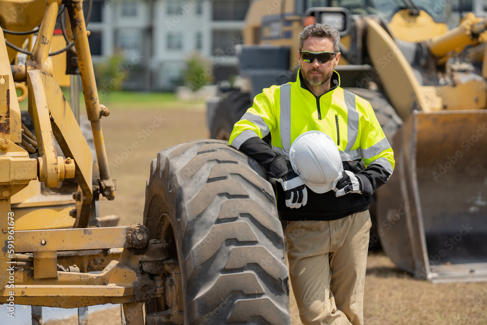 Machinery builder at buildings background. Excavator loader tractor and ...
