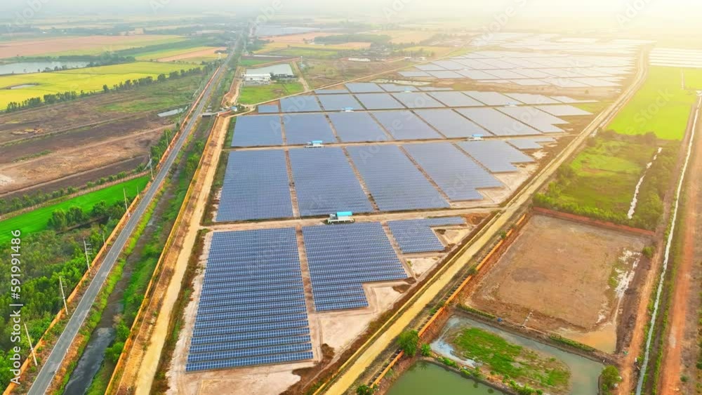 A sprawling field of photovoltaic cells arranged in rows, the solar ...