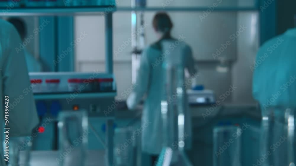 Flasks and people in chemical laboratory. Stock footage. Specialized ...