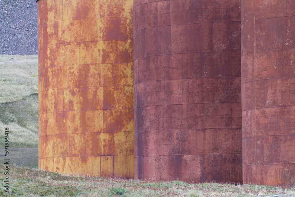 Rusty riveted storage tanks at the abandoned Stromness whaling station ...