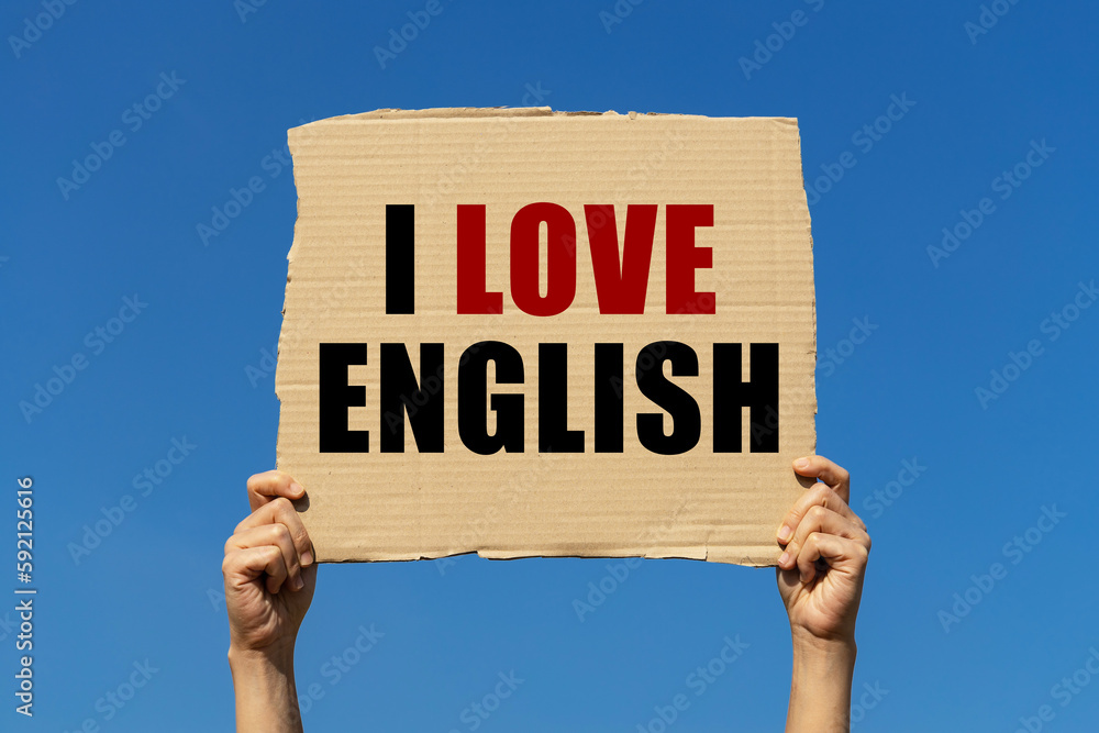 I love English text on box paper held by 2 hands with isolated blue sky ...