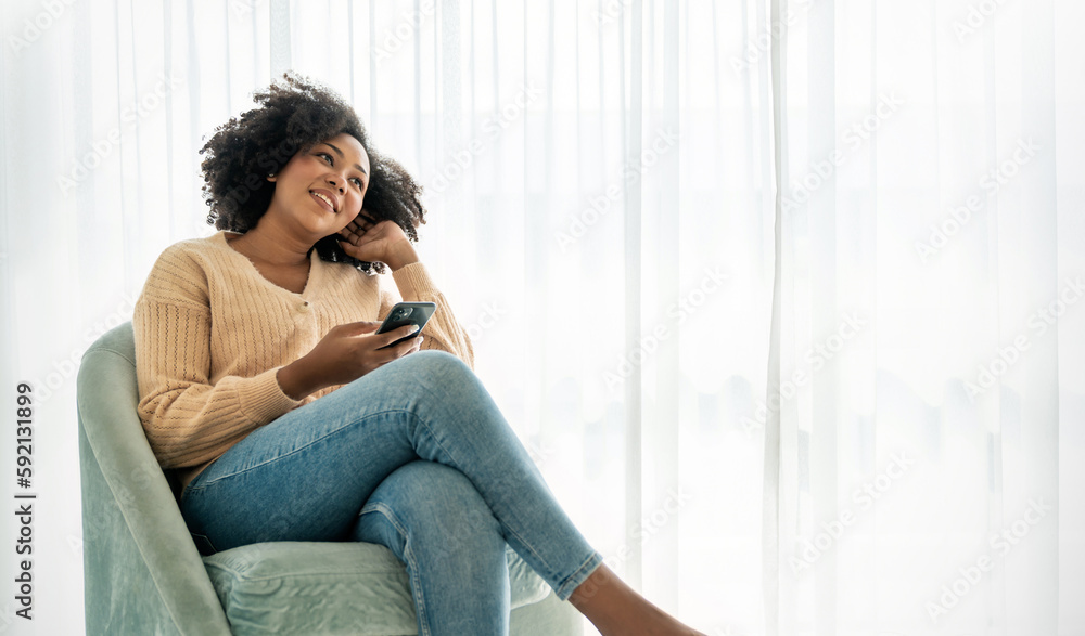 African American black woman smile use tablet smartphone in blue winter ...