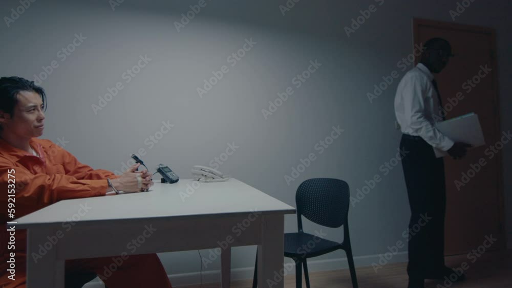 African American police detective entering an interrogation room ...