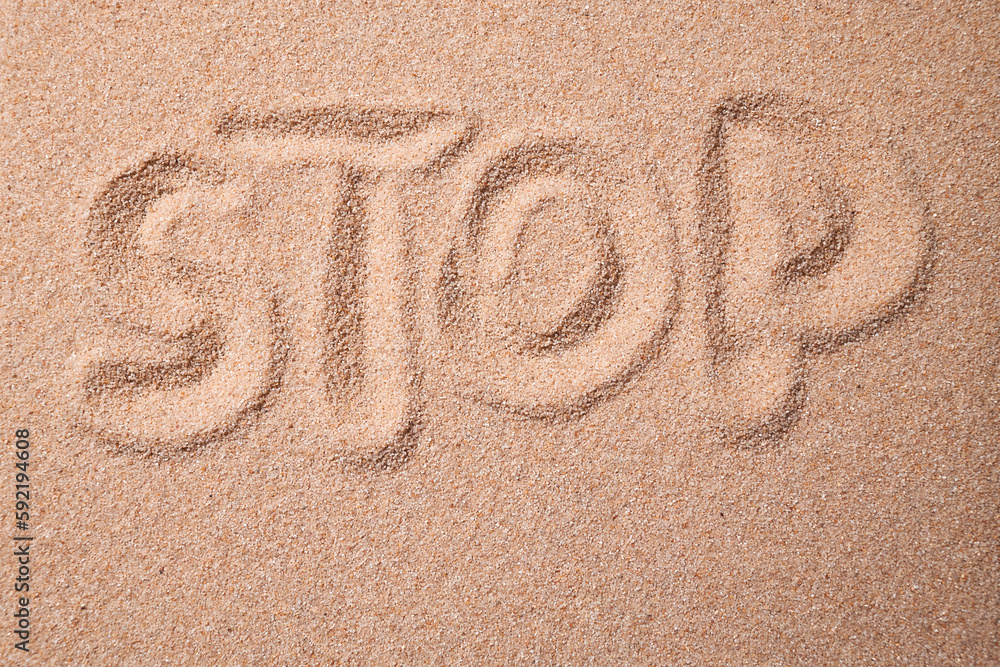 Sign of the Sands: Hand-Drawn STOP on Sandy Beach Stock Photo | Adobe Stock