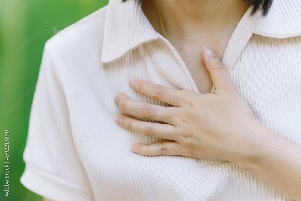 A woman has chest pain due to acute heart failure. Health care concept ...