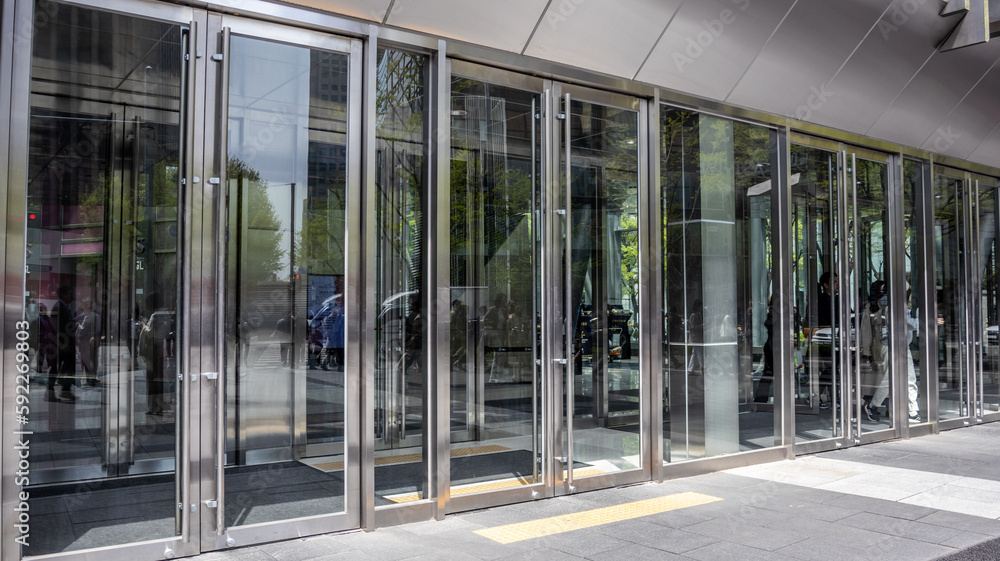The main entrance doors of a high-rise building lobby Stock Photo ...