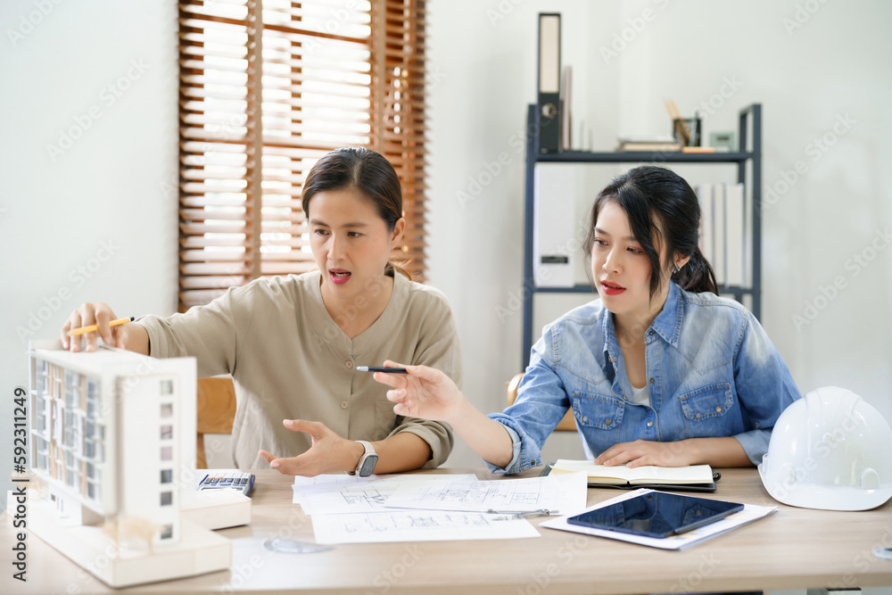 Concept of engineering consulting, Two female engineers pointing and ...