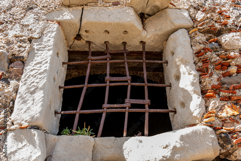 iron-barred window of an old prison in a tiny Sicilian village called ...