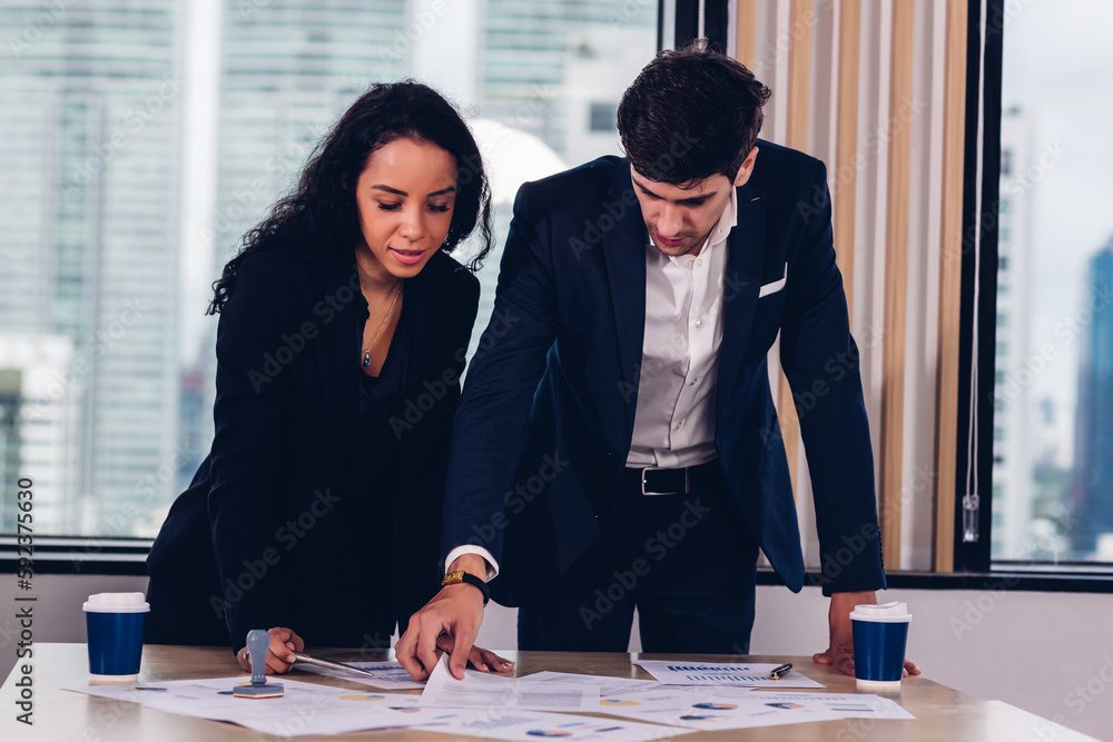Foto de Diverse colleagues gather in brainstorm discuss statistics together. Group of people ...
