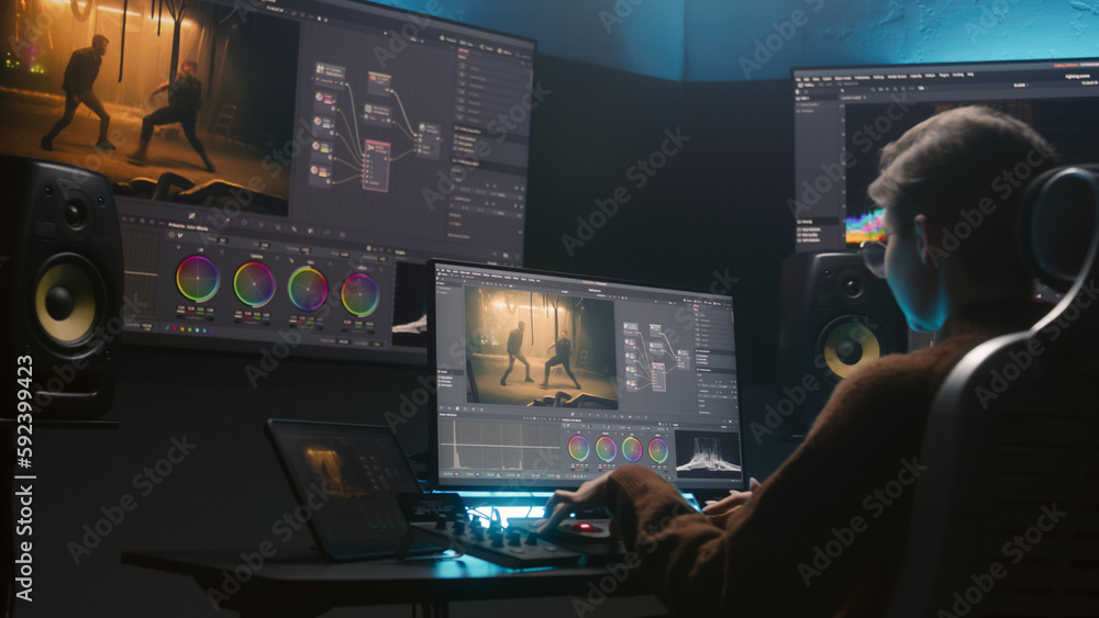 Female colorist uses color grading control panel, edits video, makes ...