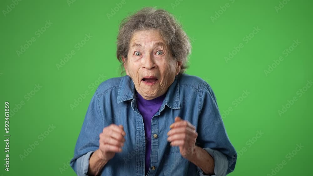 Portrait of excited winner smiling elderly senior old woman with ...