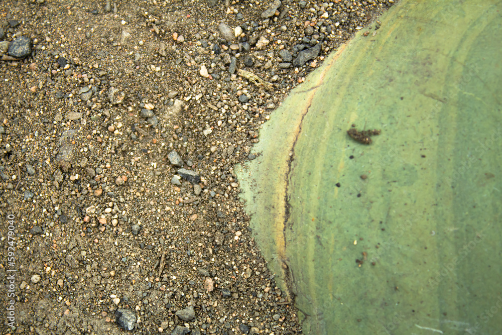 Sandy background with big green stone. Texture, background. Stock Photo ...