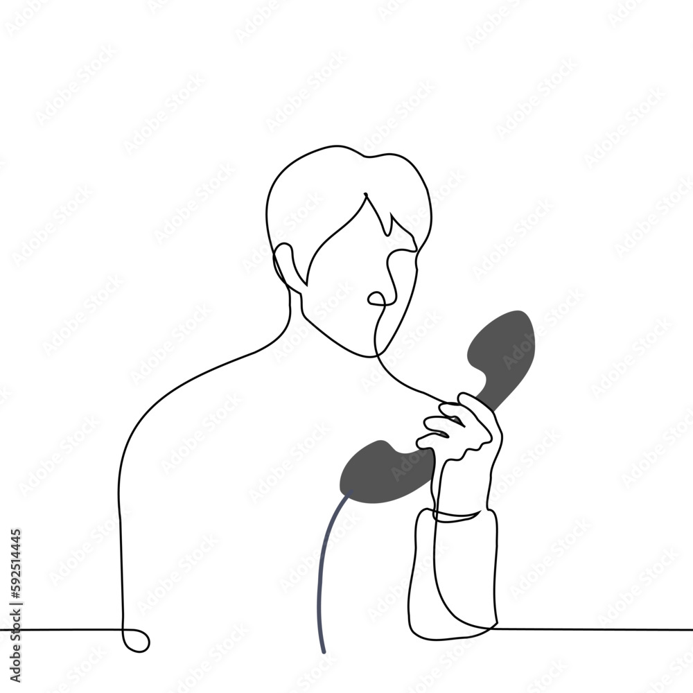 man holds a tube of a vintage telephone set with a wire in his hand, he ...