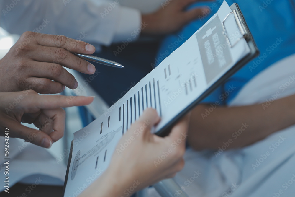 Injured patient showing doctor broken wrist and arm with bandage in ...