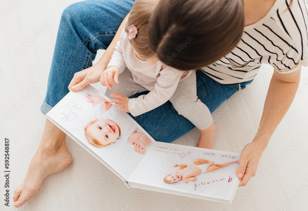 mother and daughter watch photobook from discharge of newborn baby ...